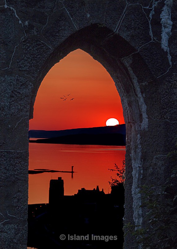 Sun setting through the window of McCaigs Tower